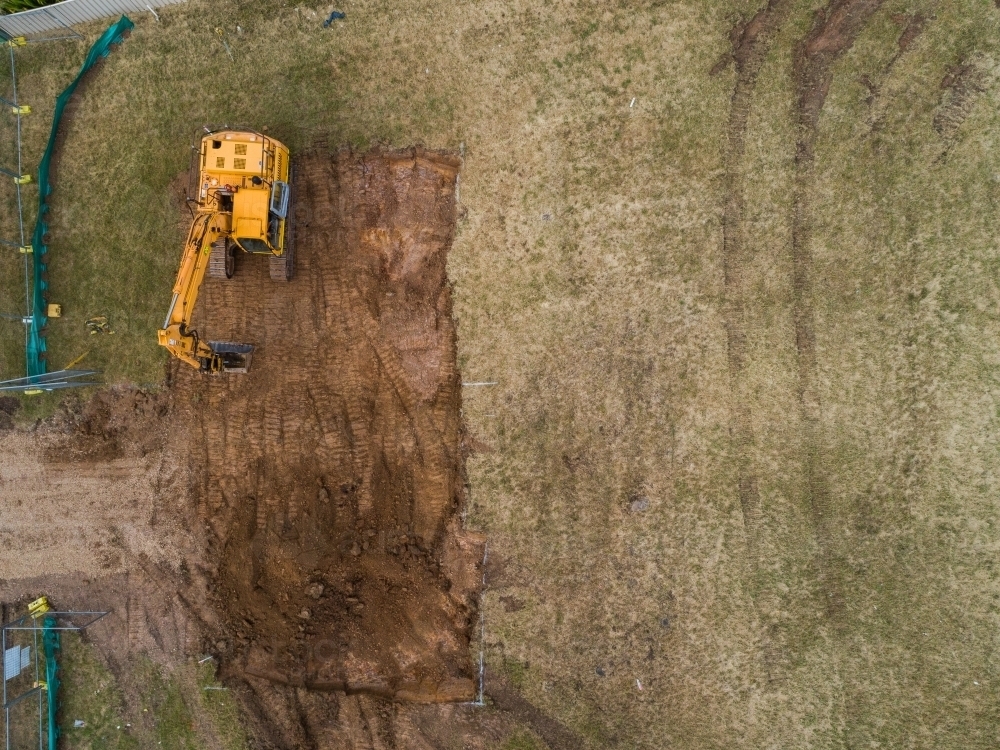Image of Construction site with digger levelling out ground for house ...