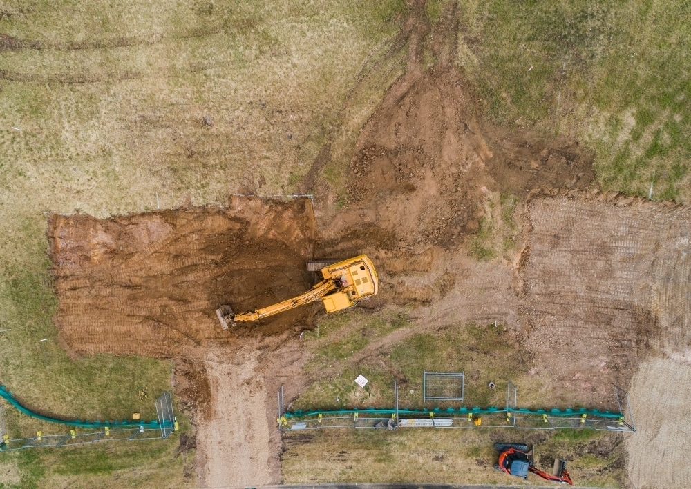 Image of Construction site with digger levelling out ground for house ...