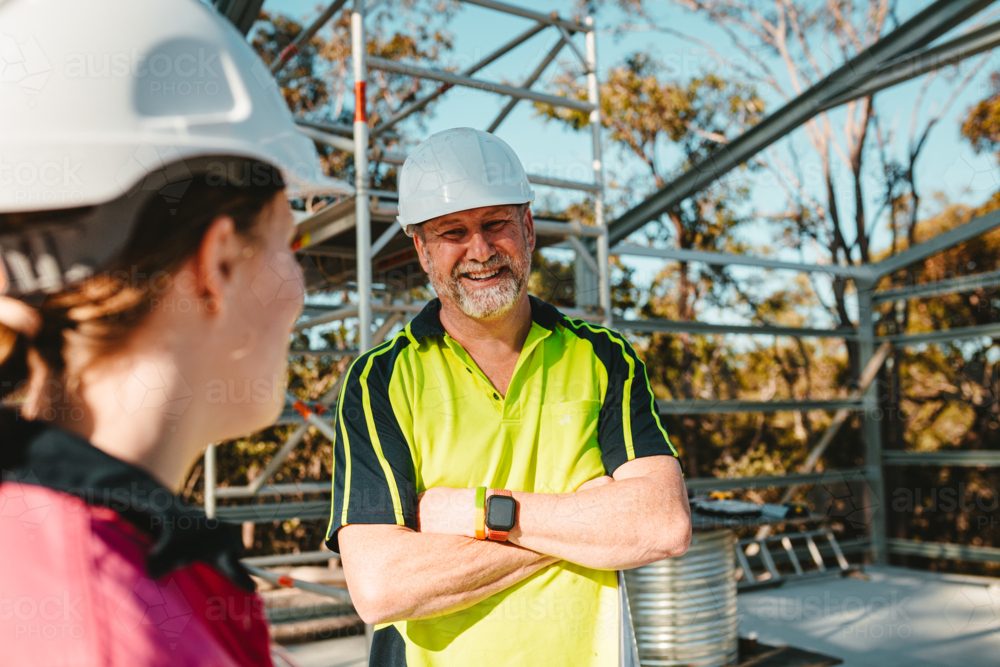 Image of Construction workers looking and talking at the construction ...