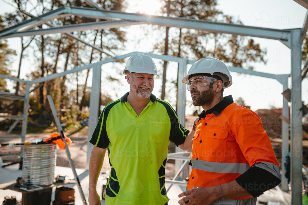 Image of Construction workers looking and talking at the construction ...