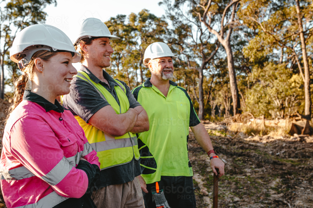 Image of Construction workers standing with arms crossed at the ...