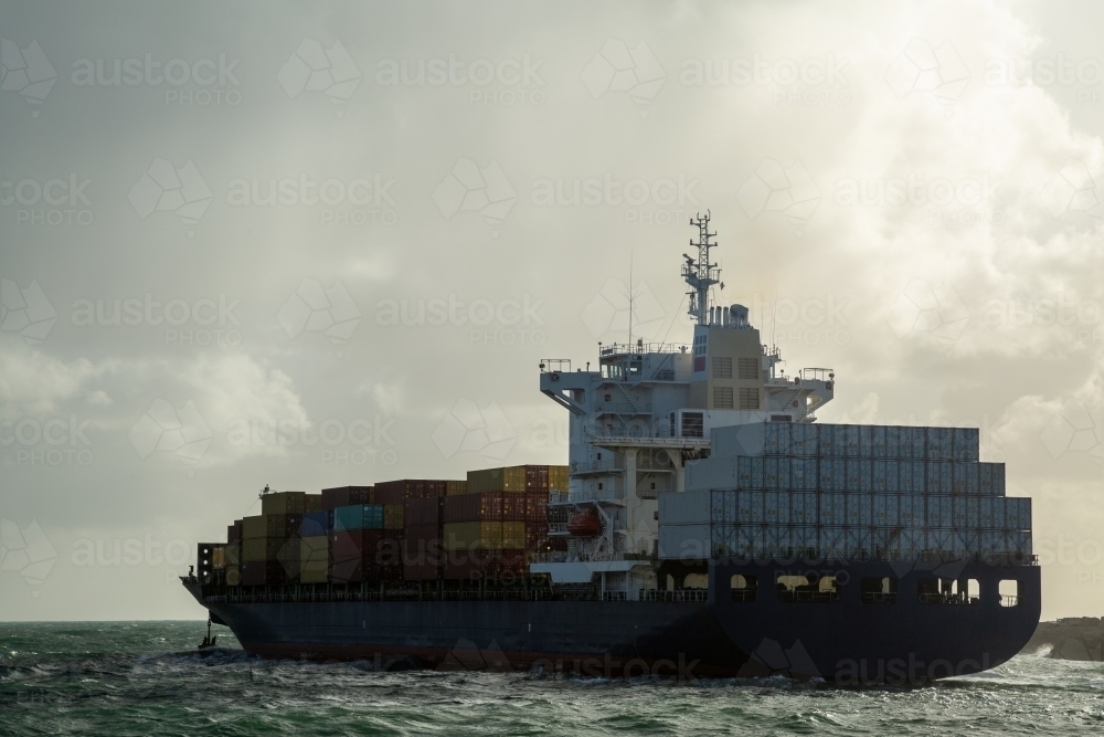 Image of Container ship departing Port of Fremantle. - Austockphoto