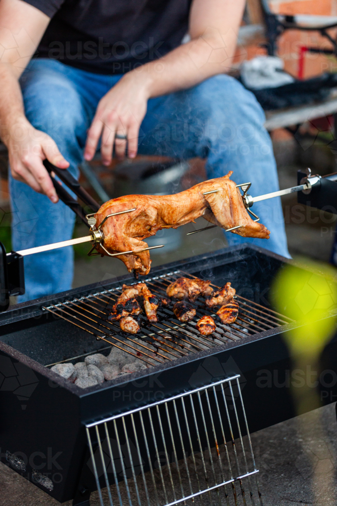 Image of cooking chicken and rabbit over charcoal fire pit grill in ...