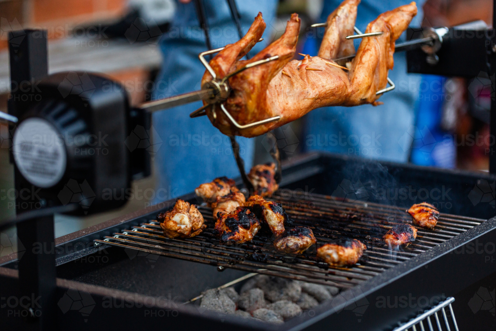 Image of cooking chicken over charcoal fire pit grill in backyard ...