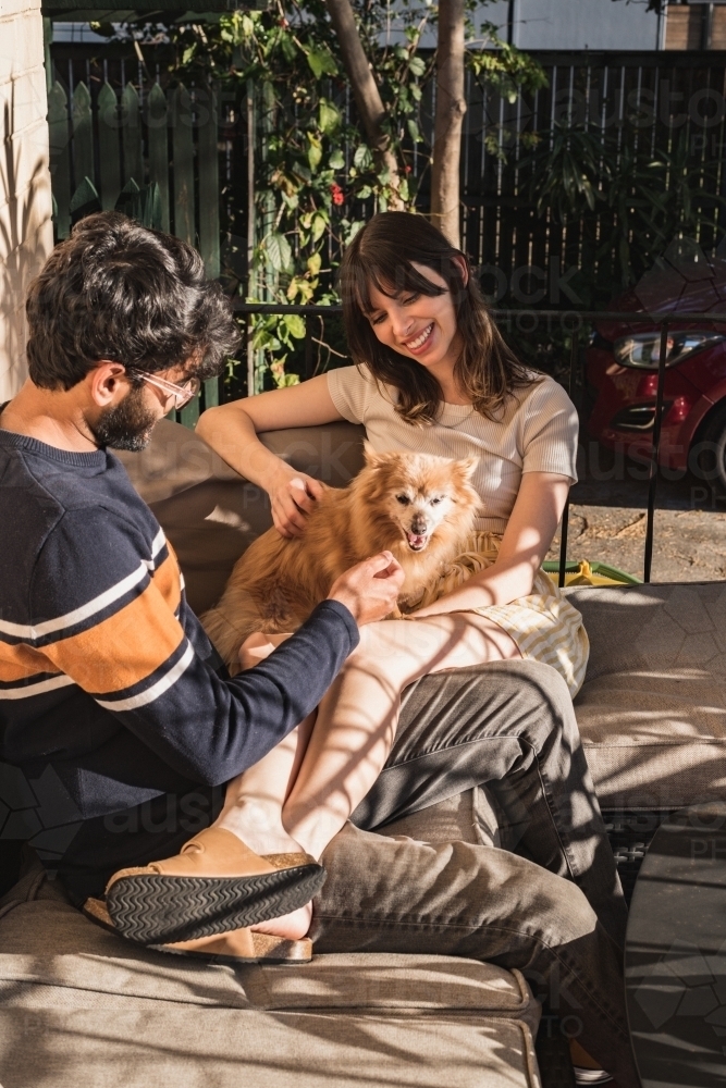 Image of couple at home on their veranda, with their rescue dog, ugc ...