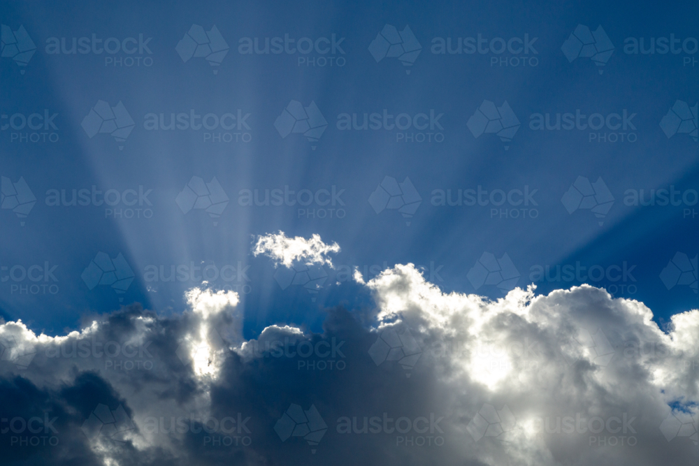 Image of Crepuscular rays, or God beams, emerging from behind white ...