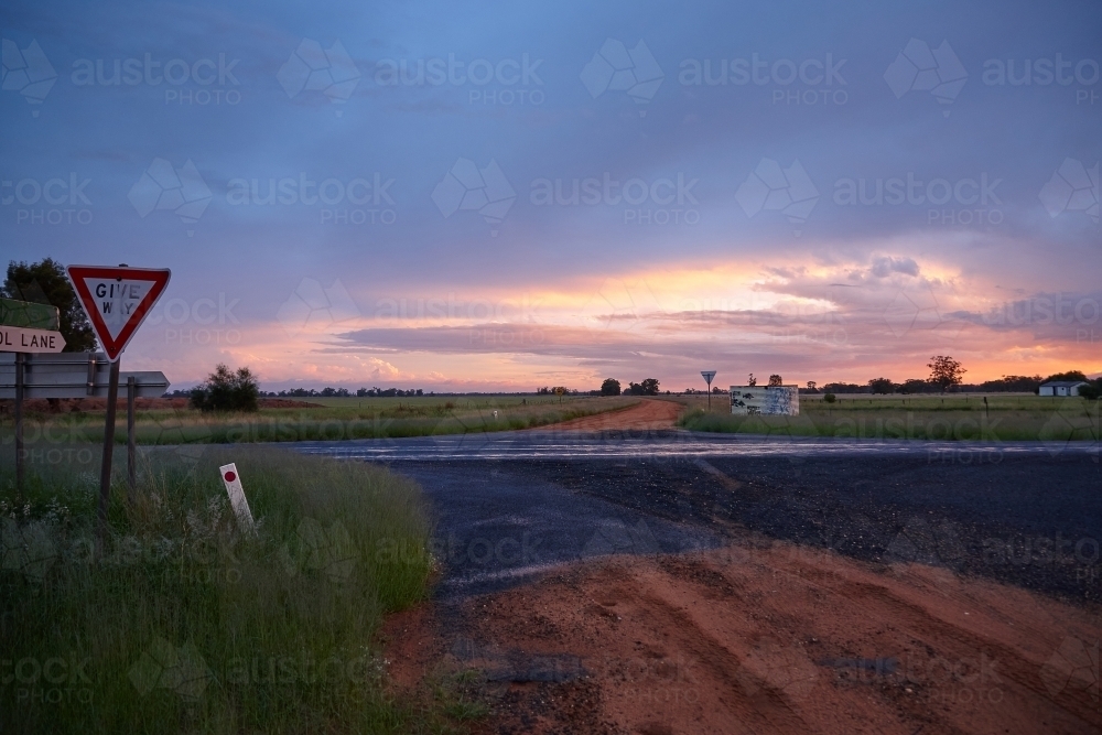 Image of Crossroad on rural highway at sunset - Austockphoto