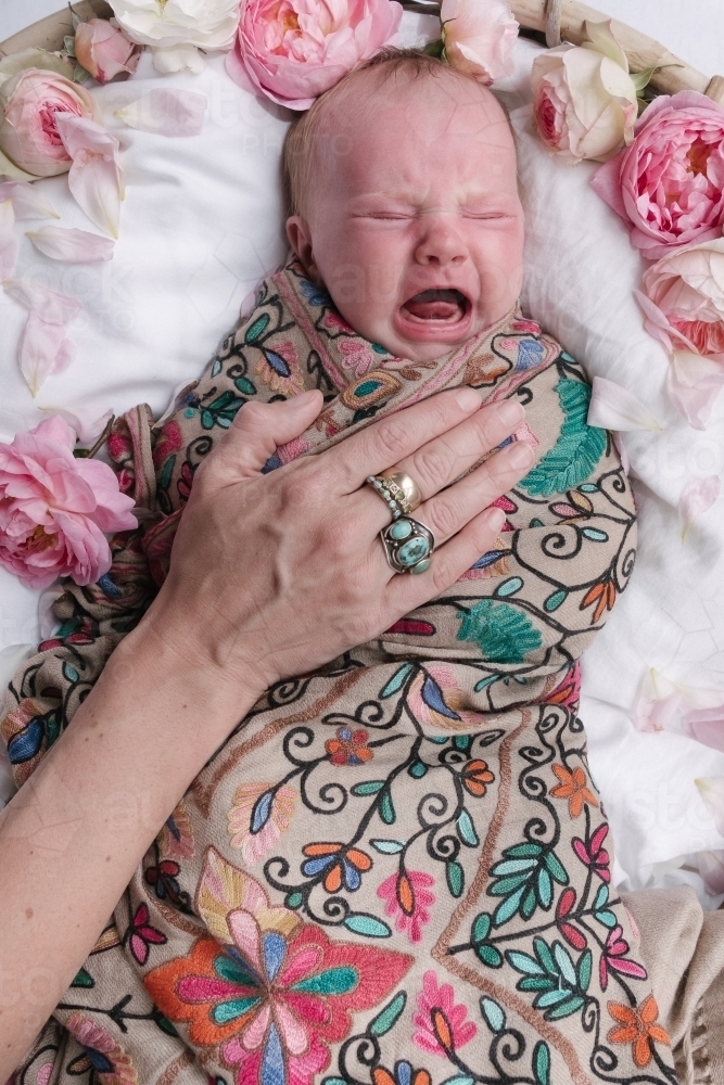 Image of Crying baby and mothers hand. - Austockphoto