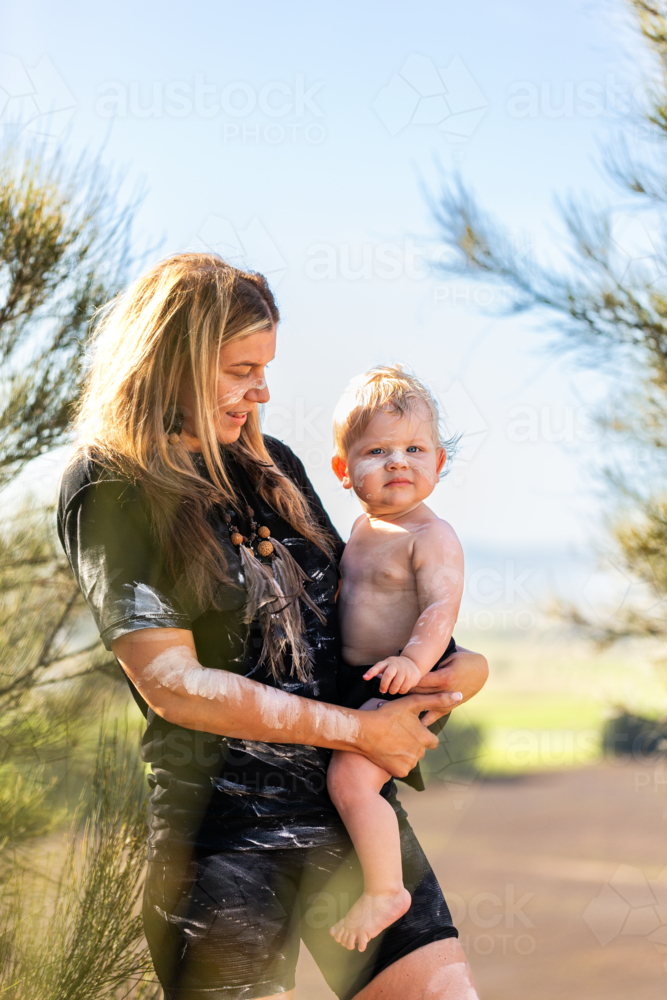 Image of Cultural image of First nations Australian mother holding son ...