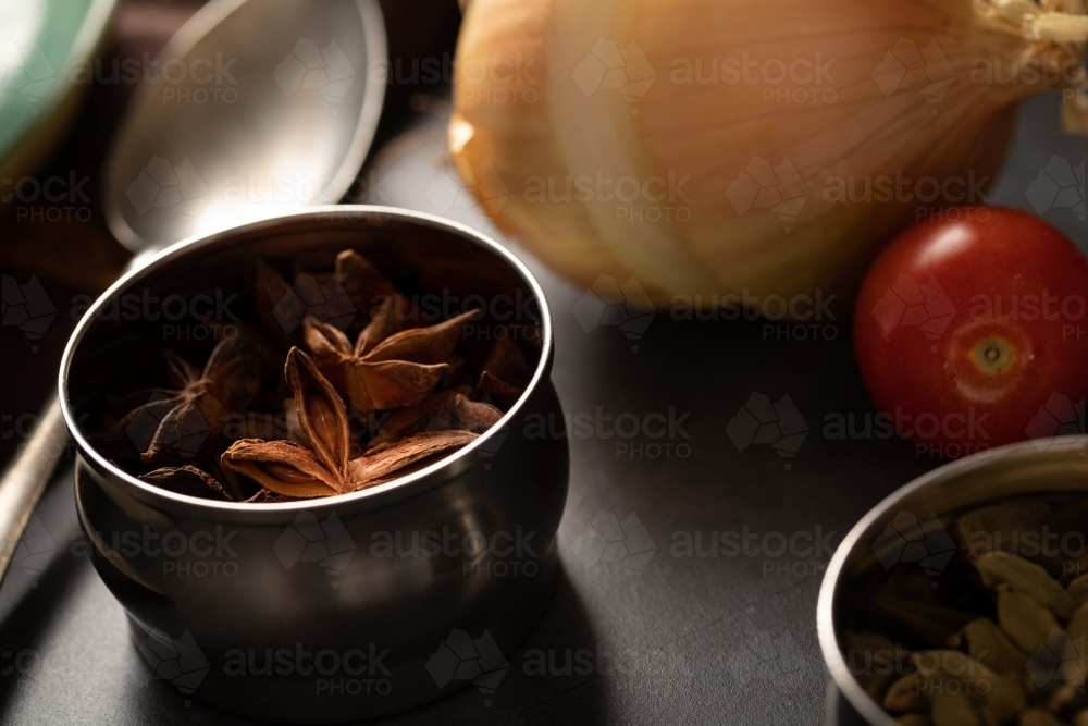 Image of Curry ingredients with tin of star anise - Austockphoto