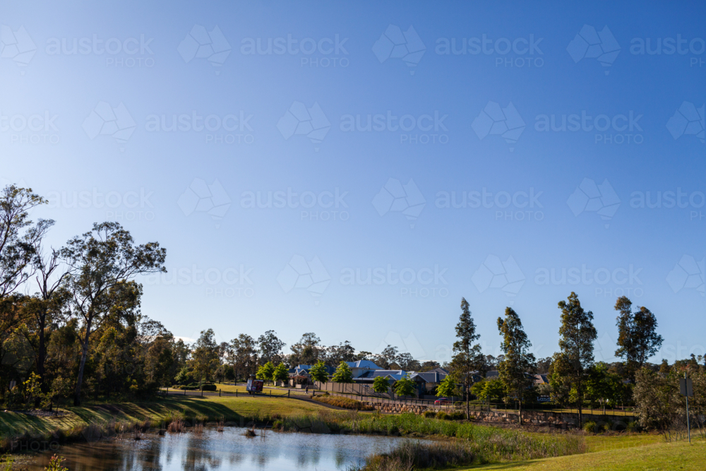 Image of dam in green strip between housing suburbs of Huntlee, NSW ...