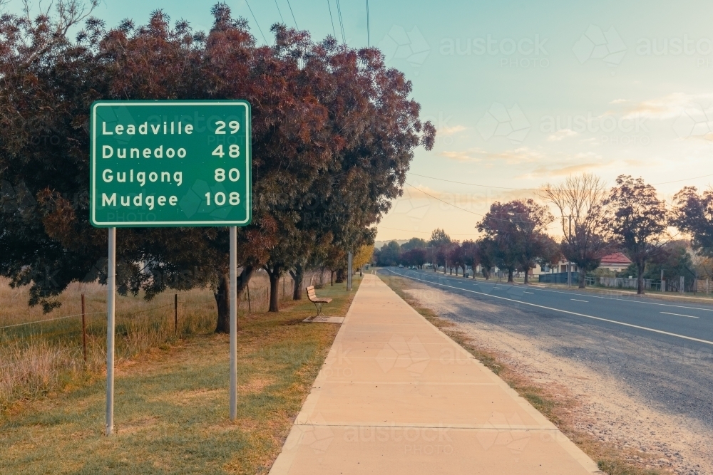 Image of Destination green road sign on way out of small regional town ...