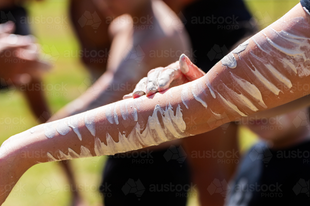 Image of Detail of Aboriginal person applying ochre paint to skin ...