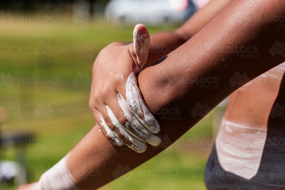 Image of Detail of Aboriginal person applying ochre paint to skin ...