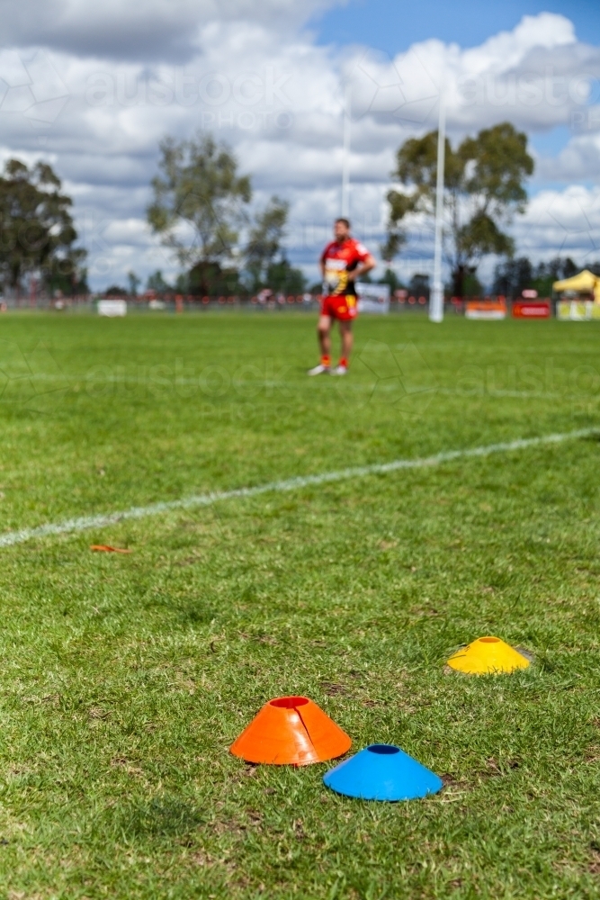 Image of Detail of colourful cones on sporting field - Austockphoto