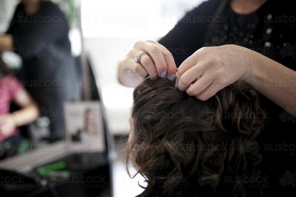 Image of Detail of hairdresser styling a woman's hair - Austockphoto