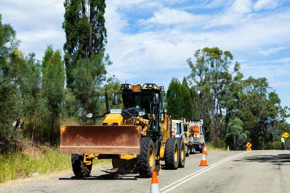 Image of Digger excavator on site for road resurfacing work on rural ...