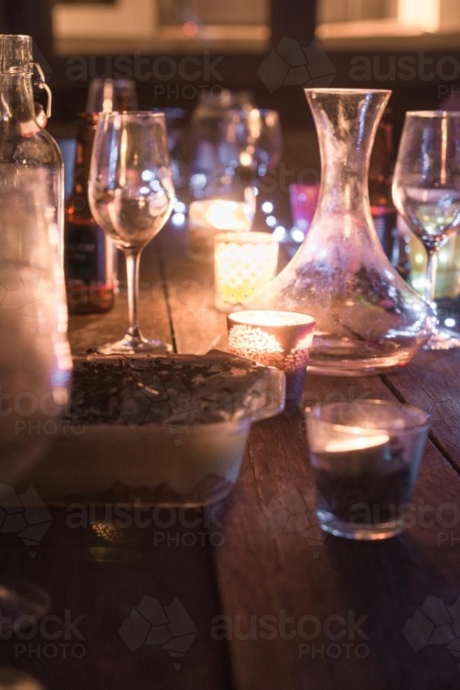 Image of dinner party table at end of the night - Austockphoto