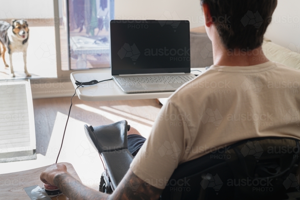 Image of disabled man using computer, with special adaptive devices ...