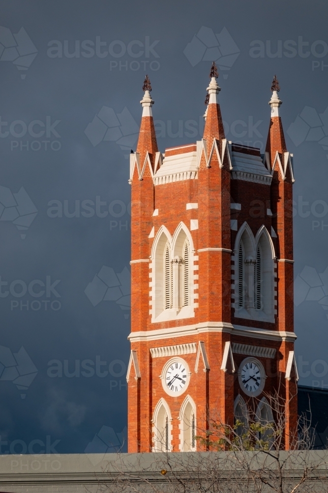 Image of Distant view of a tall historic clock tower on the front of a ...