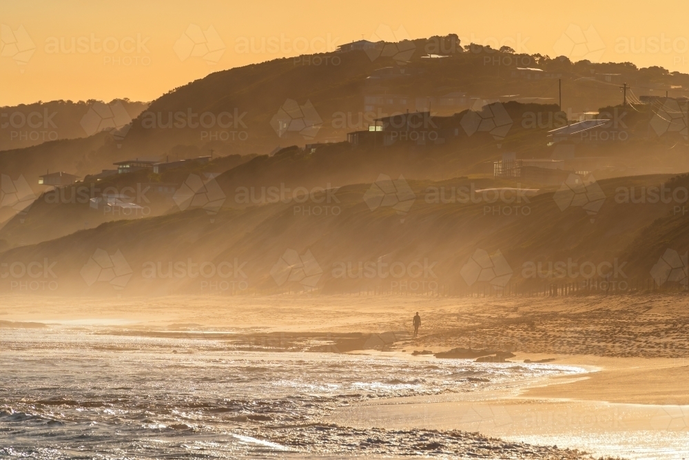Image of Distant view of sea mist rolling up over coastal hills above ...