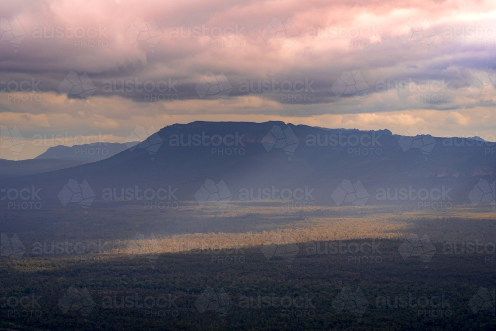 Image of Distant view of sunshine falling on a valley floor with ...
