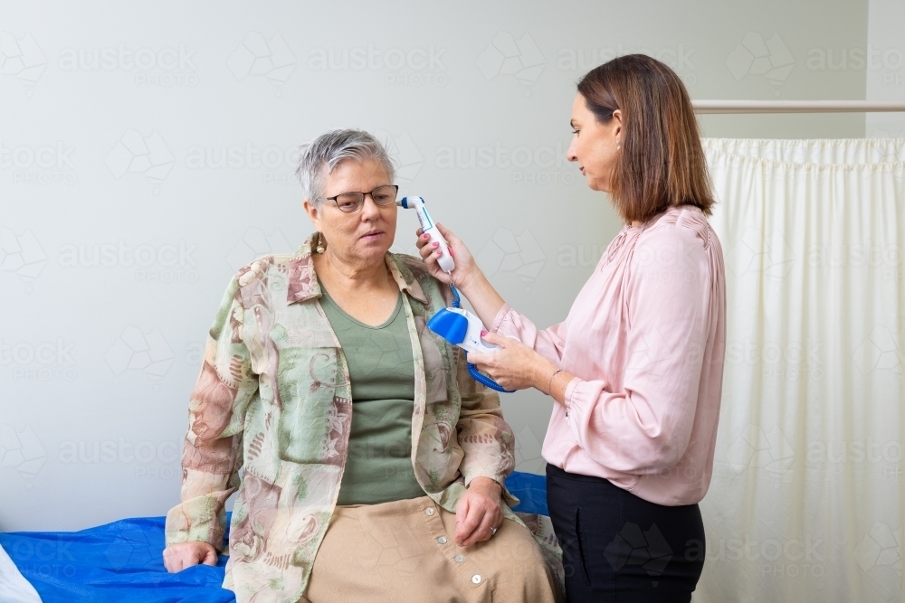 Image of doctor or nurse checking temperature of patient in surgery ...