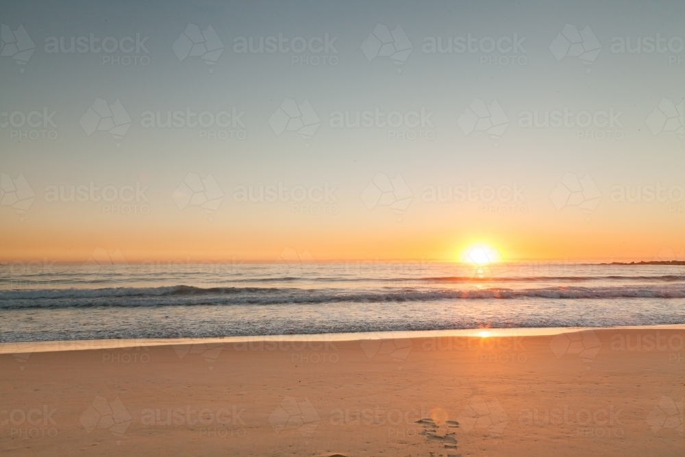 Image of Double sun star flare over ocean with clear sunrise over sea ...