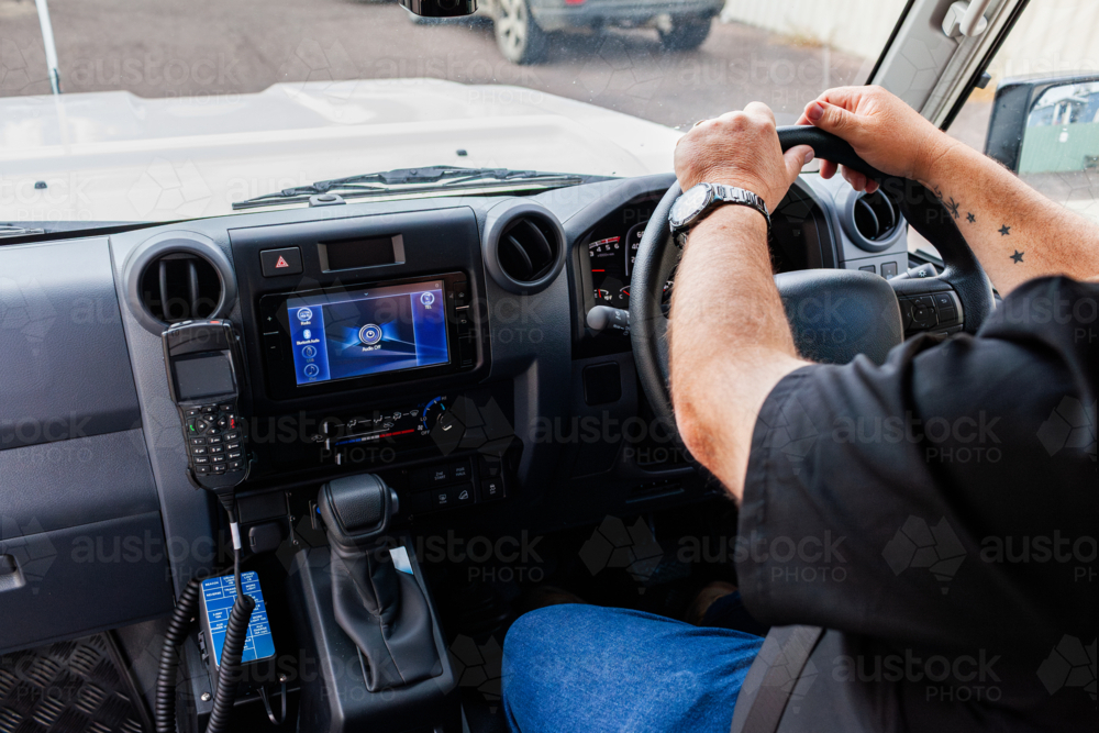 Image of driver with hands on wheel inside newly fitted out mining ...