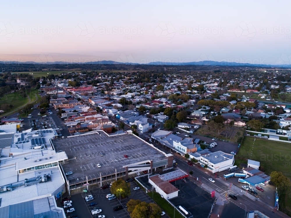 Image of Drone view of almost empty carpark and main street in country ...