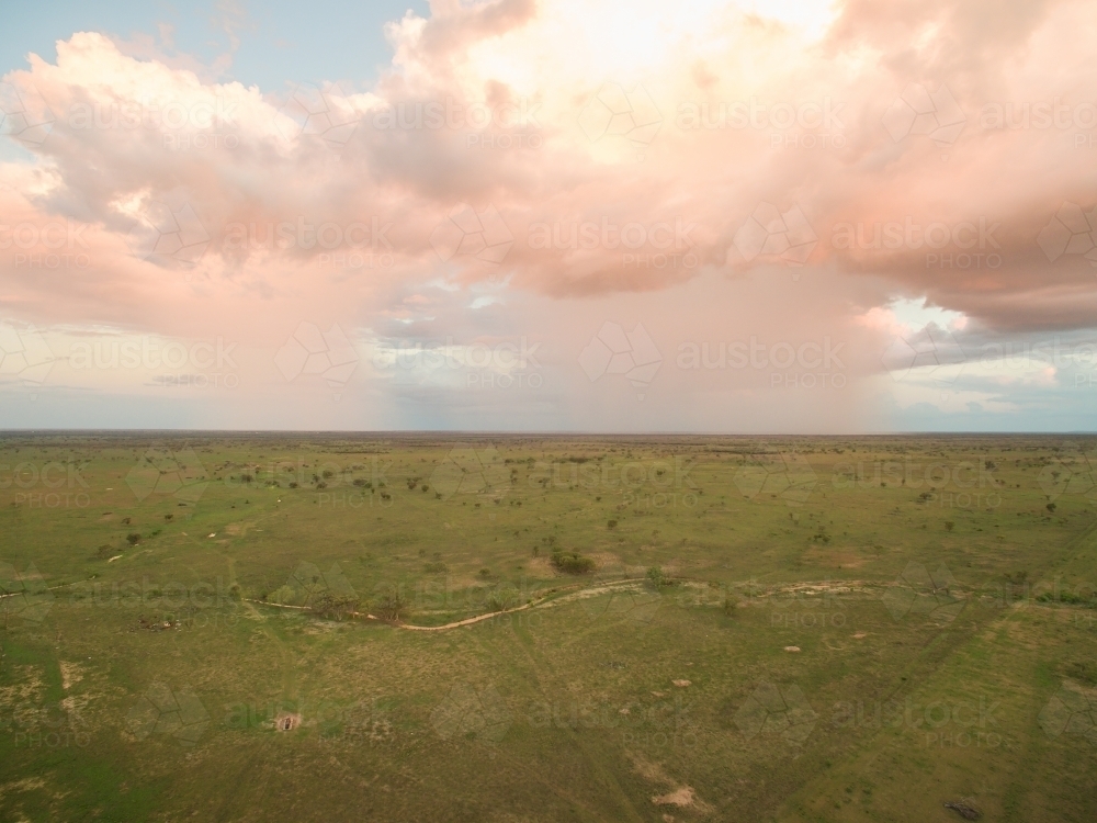 Image of Drone view of rain over green paddock - Austockphoto