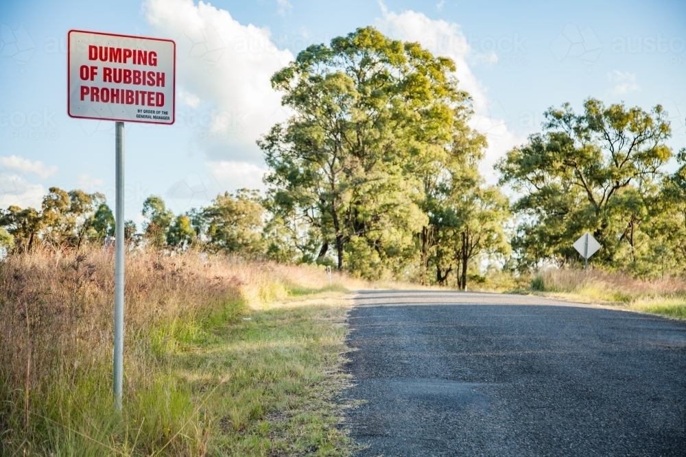 Image of Dumping of rubbish prohibited sign by the roadside - Austockphoto