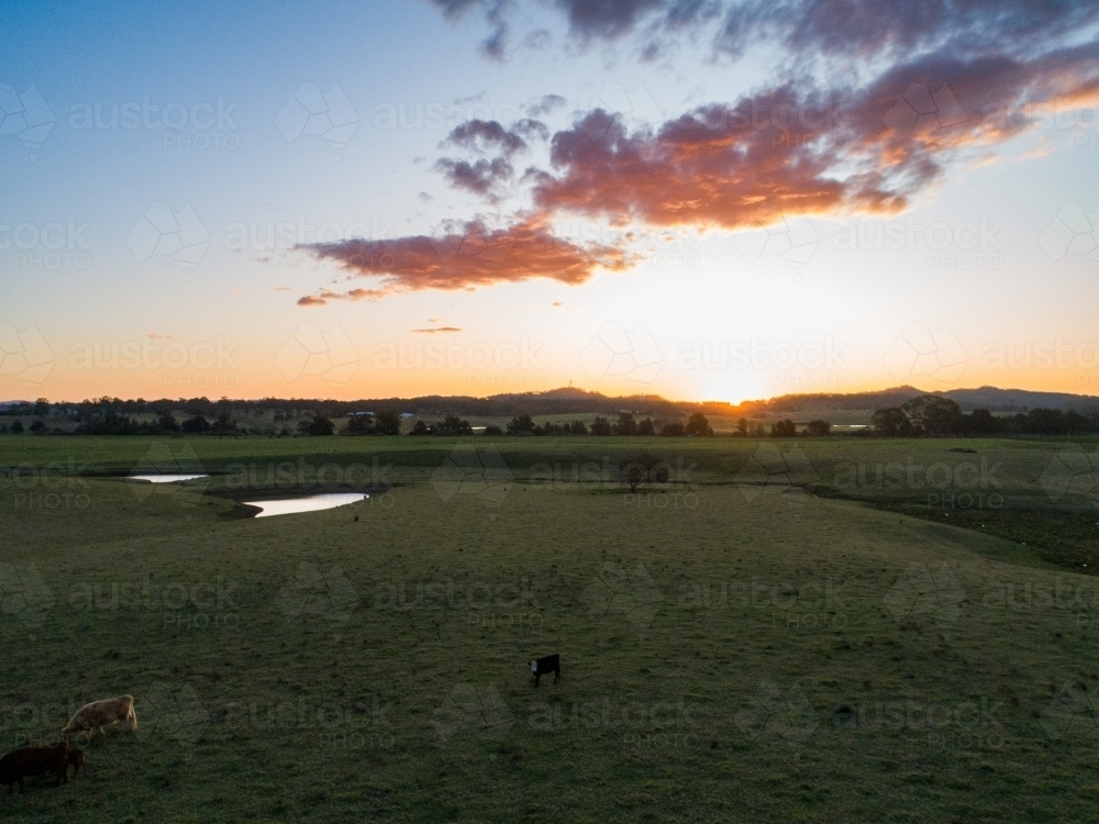 Image of Dusk light with sunset colours in clouds over dams in farm ...