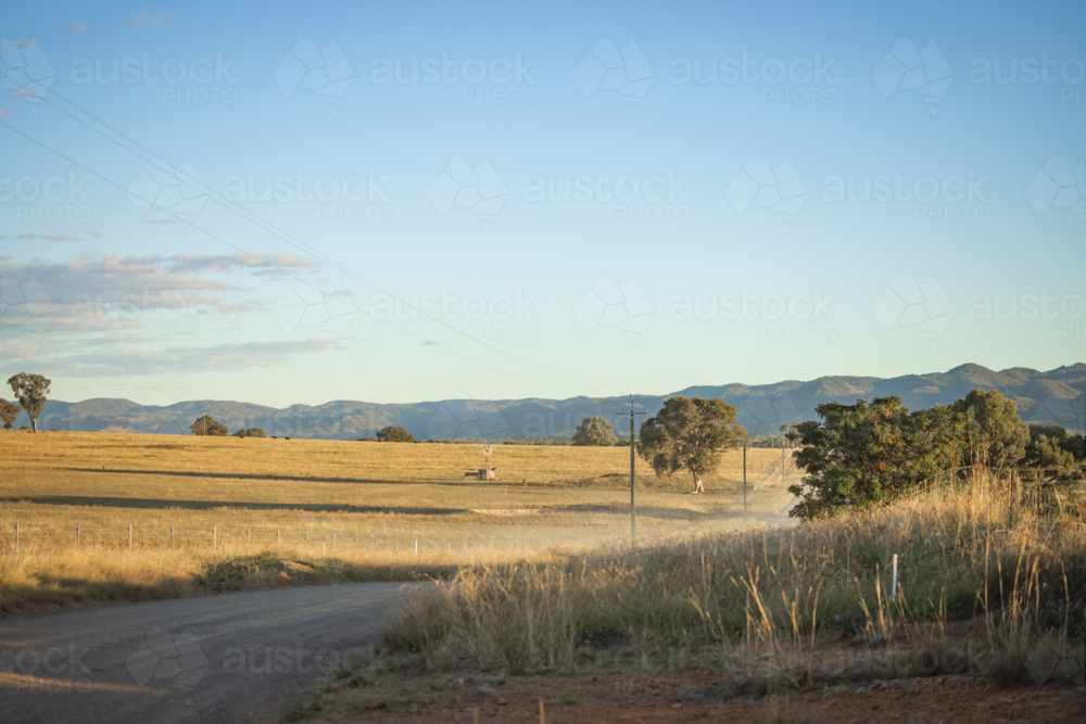Image of Dust settling on dirt road in rural Australia - Austockphoto