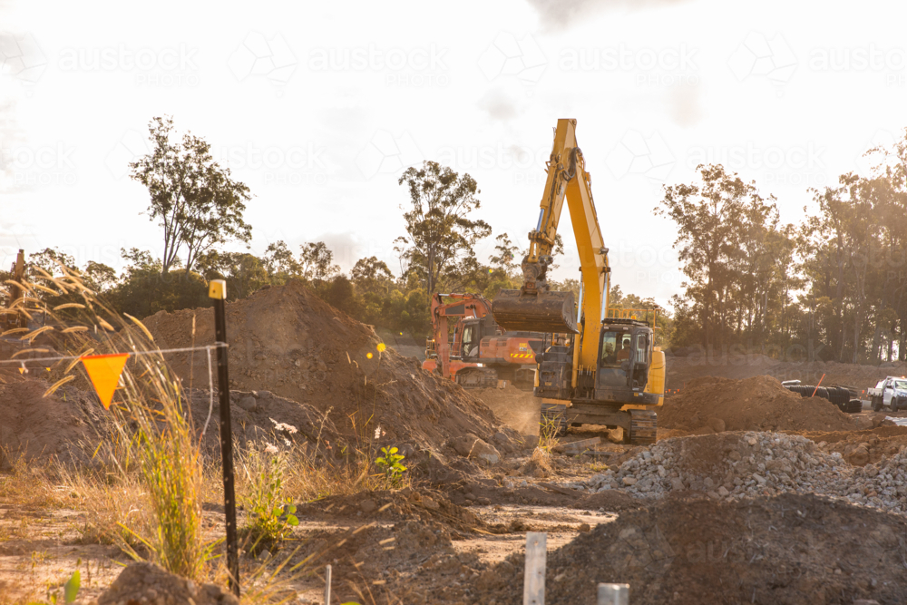 Image of earth moving machinery preparing land for housing - Austockphoto