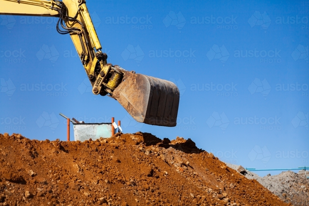 Image of Earth moving machinery working on a construction site scooping ...