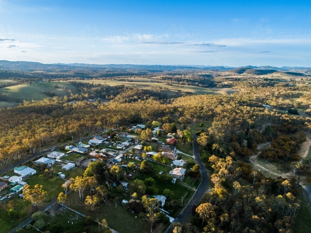 Image of Edge of country town at sunset in Australian hills - Austockphoto