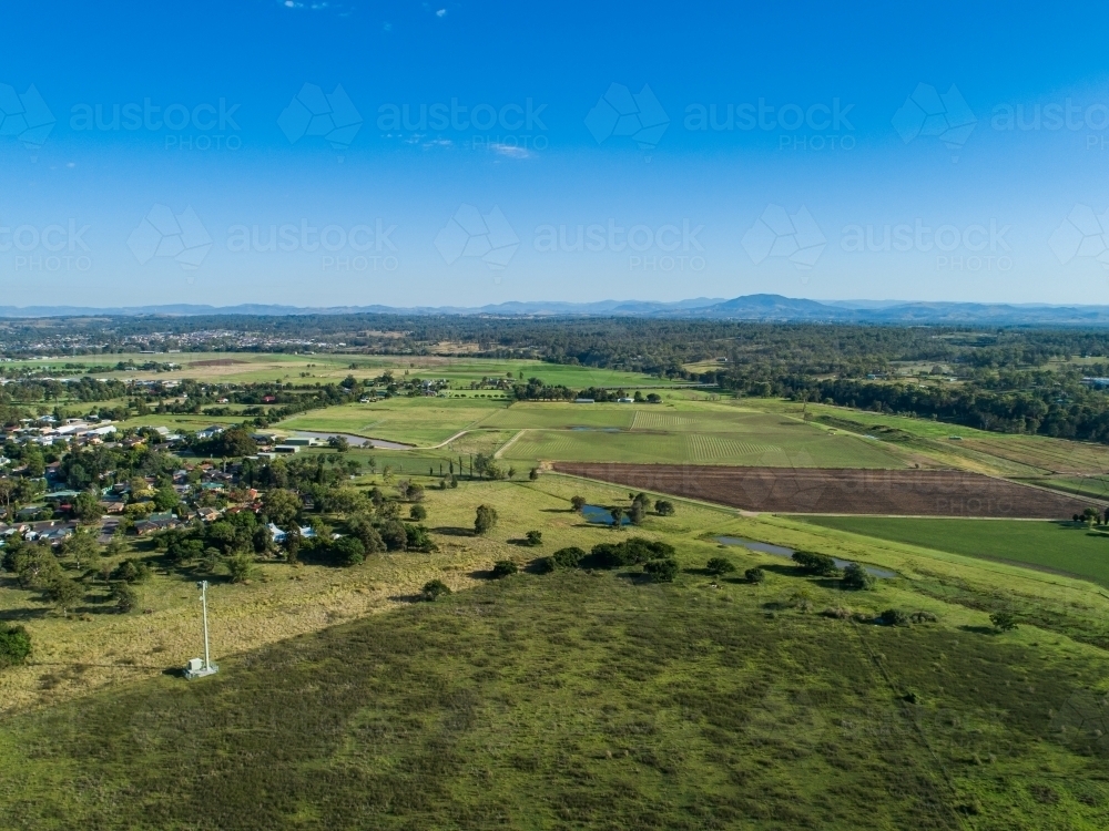 Image of edge of town, farm paddock and tree environment aerial view ...