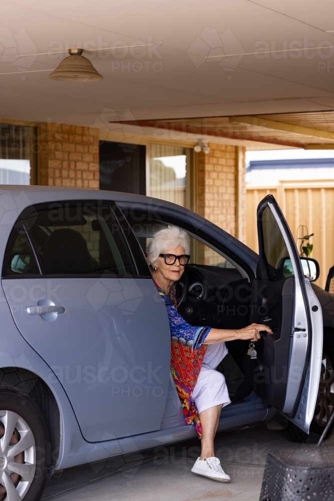 Image of elderly lady driver parked in the carport about to get out of ...