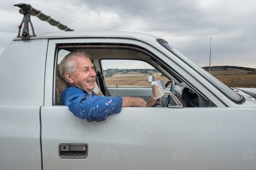 Image of Elderly man driving his ute in the countryside. - Austockphoto