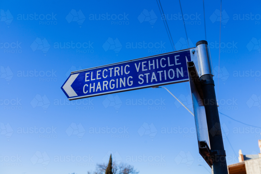 Image of Electric vehicle charging station sign on roadside against ...