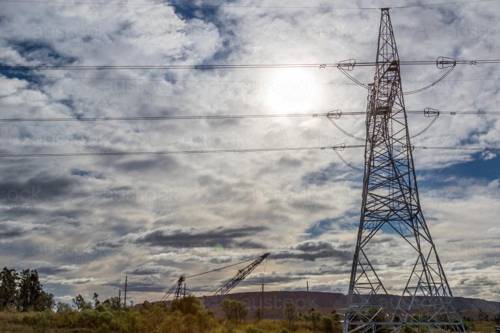 Image of Electrical power lines with mining digger - Austockphoto