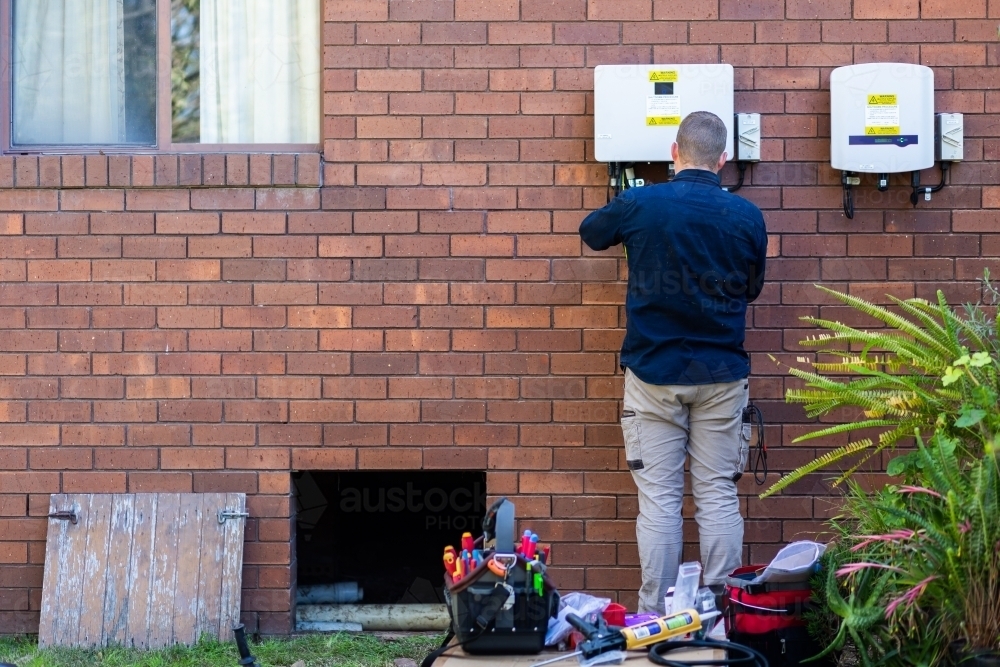 Image of Electrical tradie working as an electrician doing a solar ...