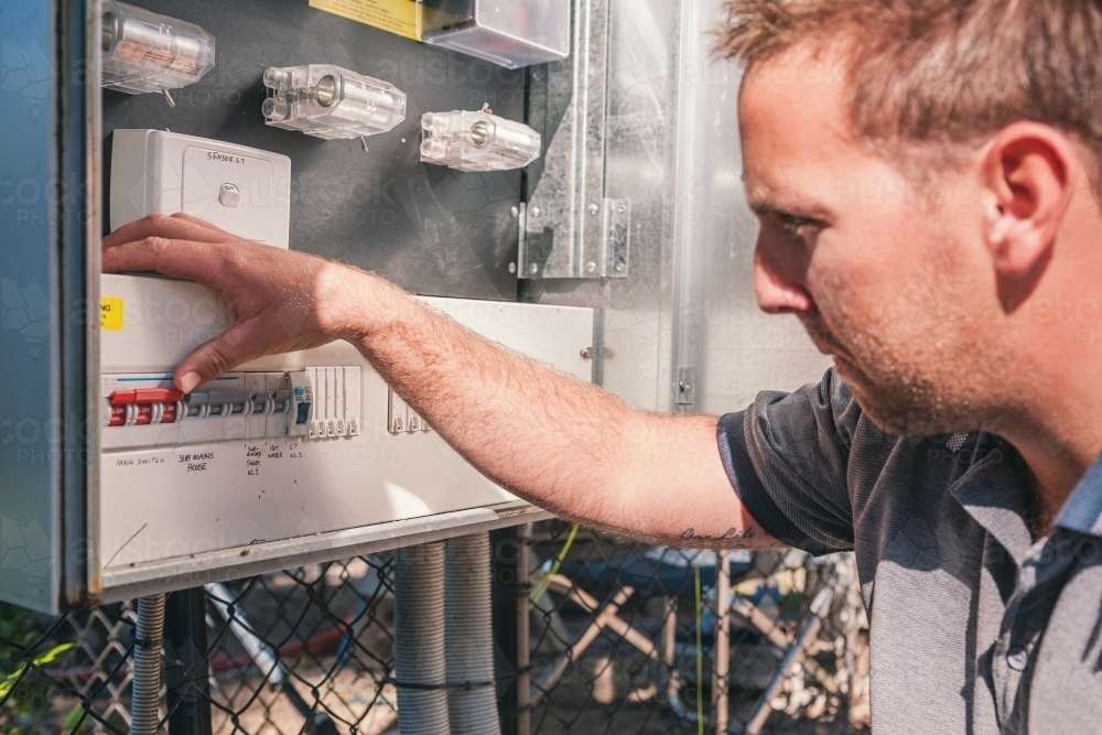 Image of Electrician checking switches at the power box - Austockphoto