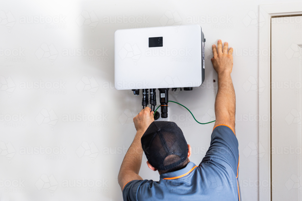Image of Electrician running wires and cables through wall for solar ...