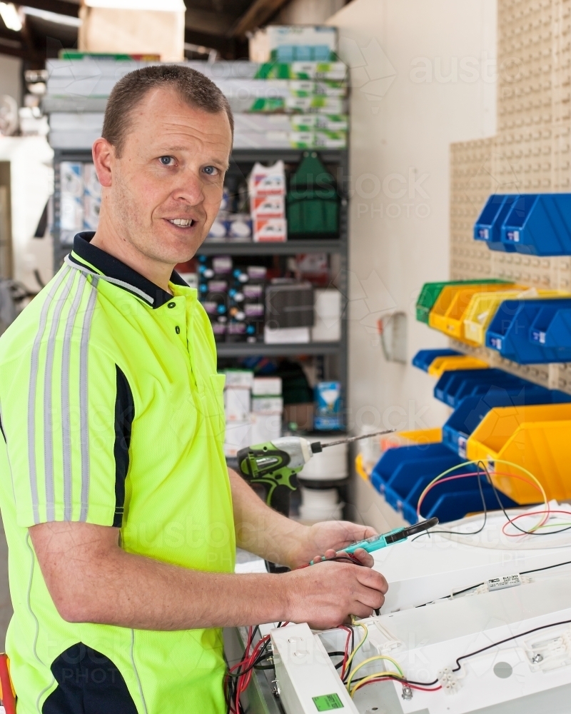 Image of Electrician testing power board with a multimeter in his ...