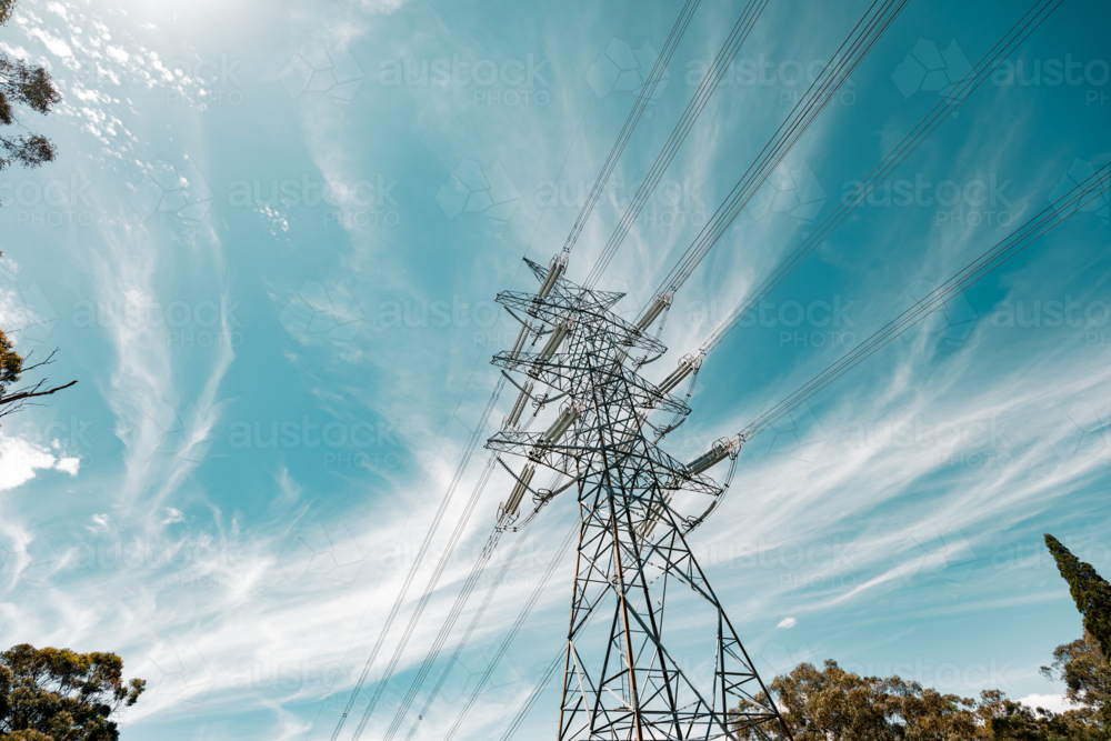 Image of Electricity pylon with dramatic clouds and blue sky ...