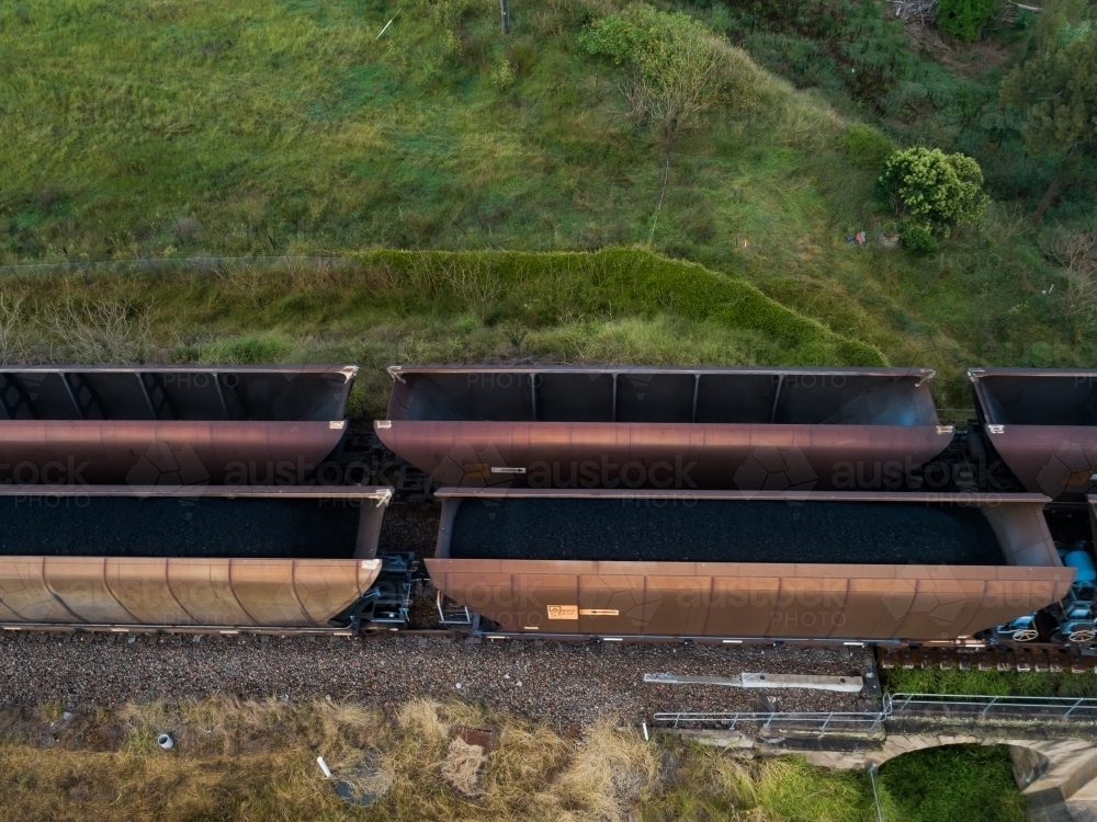Image of empty and full coal trains passing one another on railway aerial view - Austockphoto