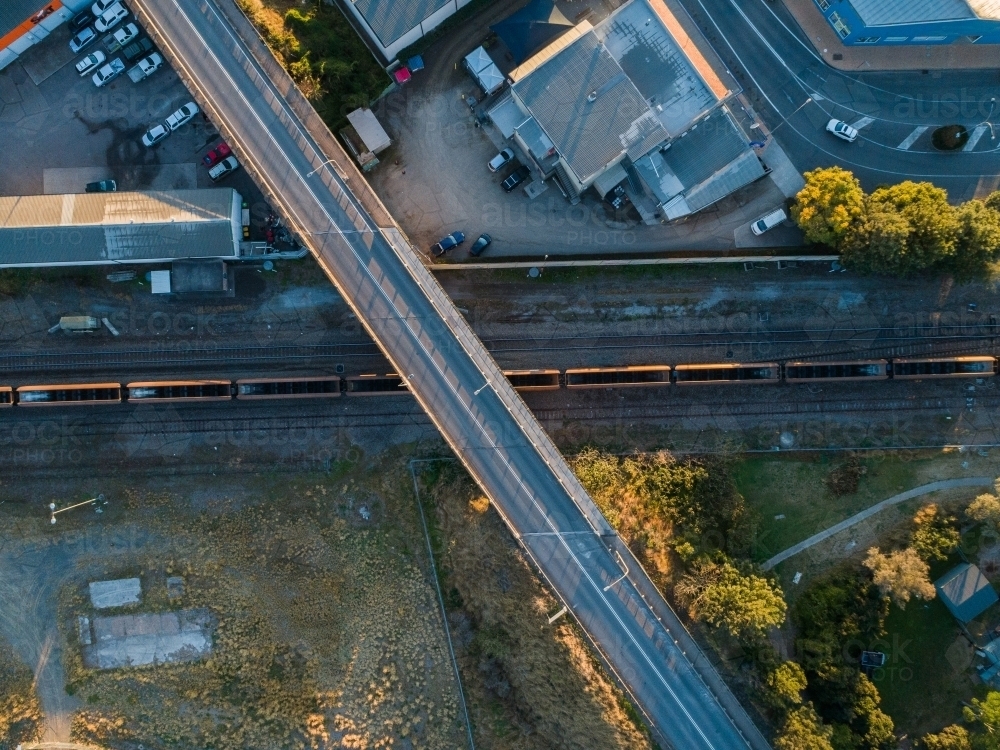 Image of Empty coal train passing under bridge over railway seem from ...