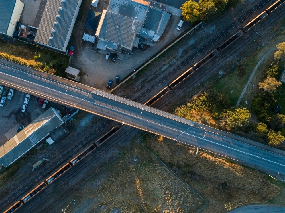 Image of Empty coal train passing under bridge over railway seen from ...